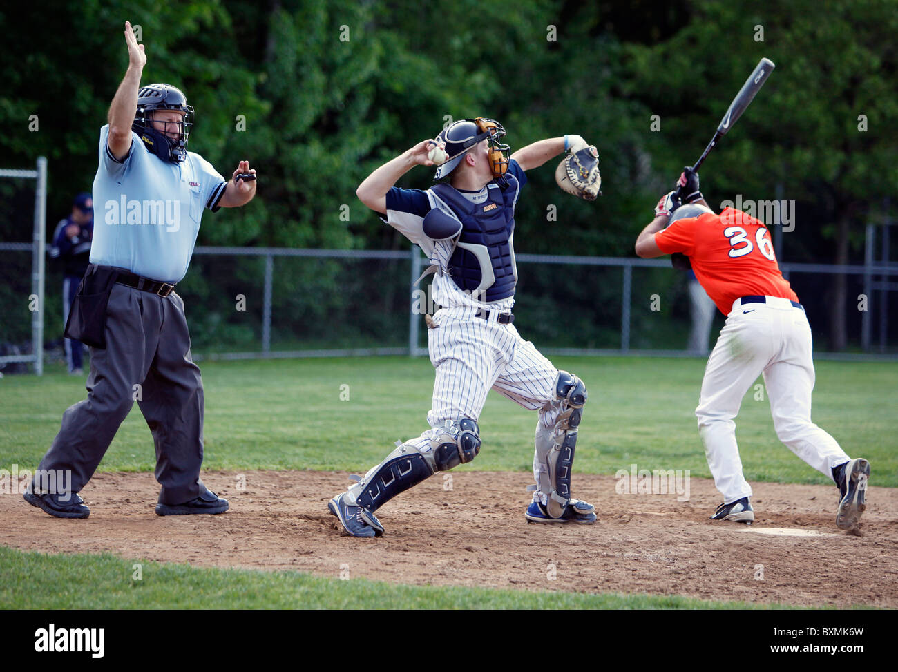 A batter shows frustration after striking out in an American high ...