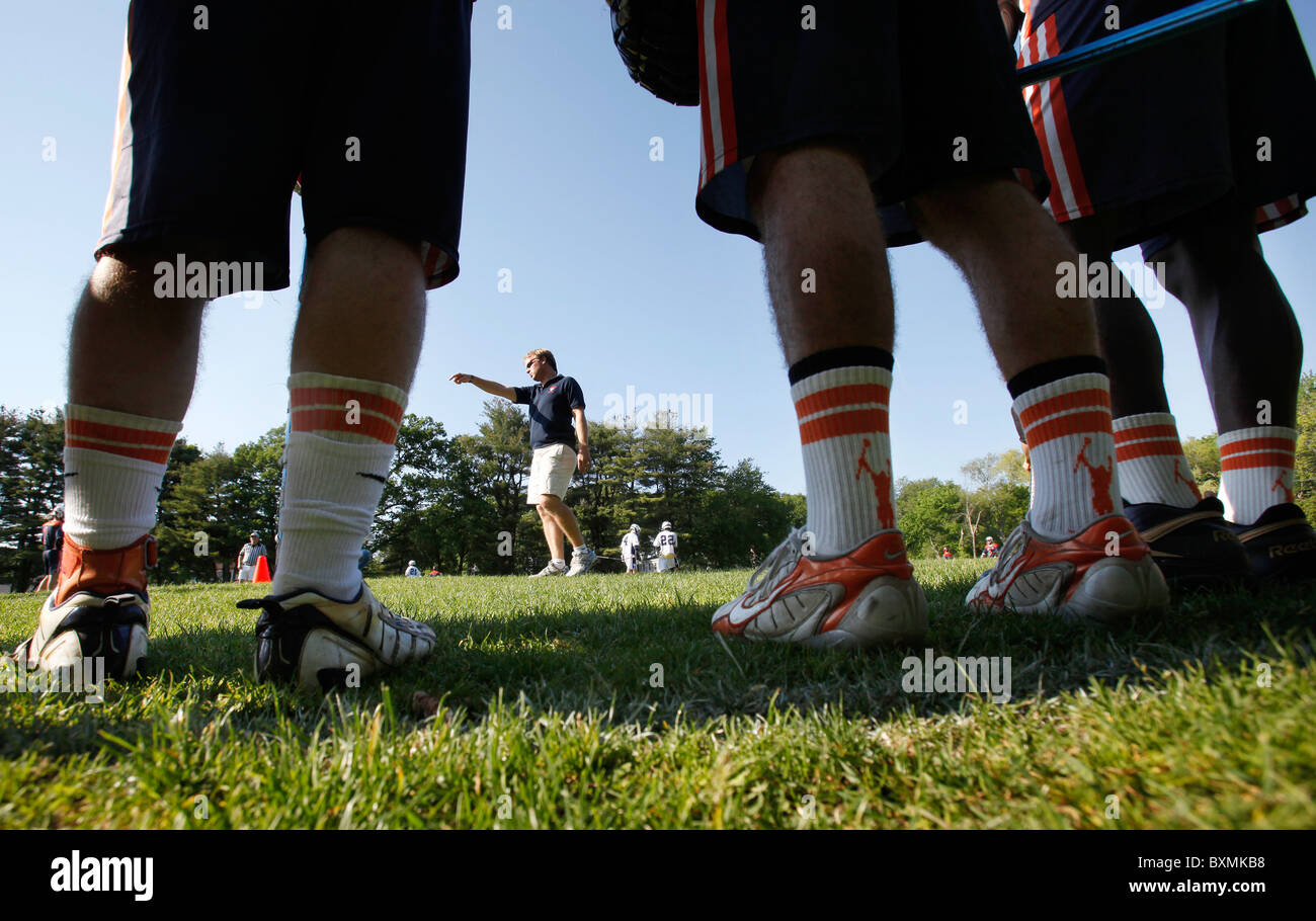 The coach, center, instructs the team during an American high school ...