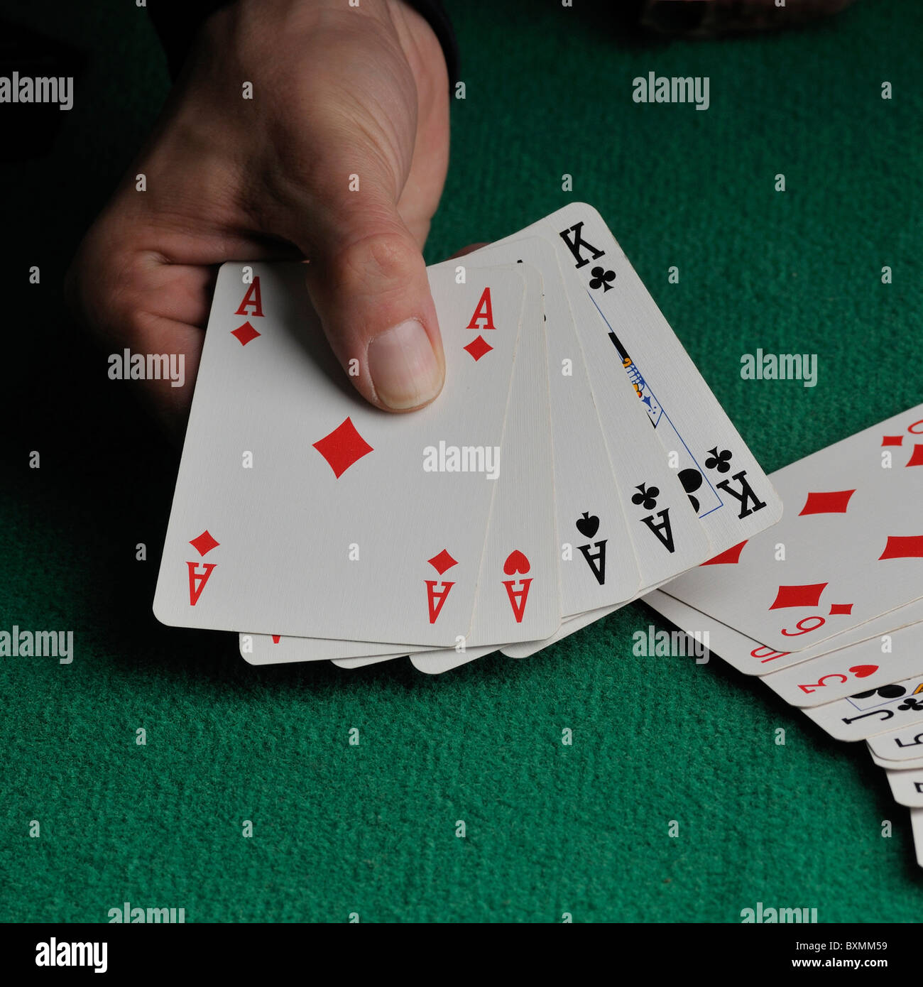 four aces with hand on green background Stock Photo - Alamy