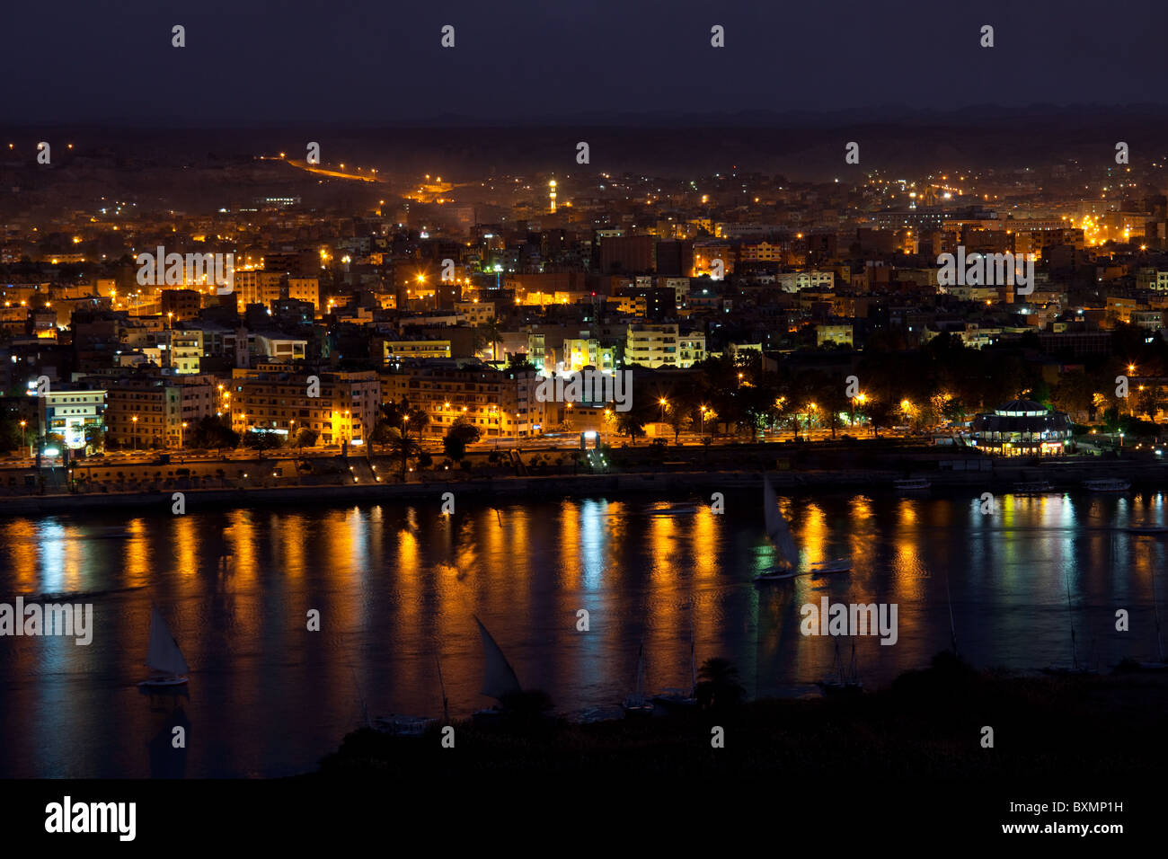 Nile River flowing through town at night, Aswan, Egypt Stock Photo - Alamy