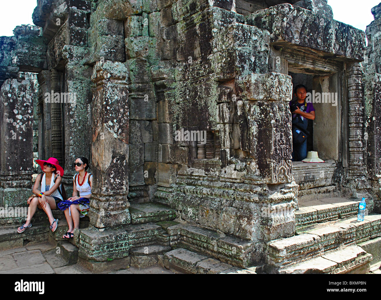 Tourist taking photographs in Cambodian temples around Angkor Wat Stock ...