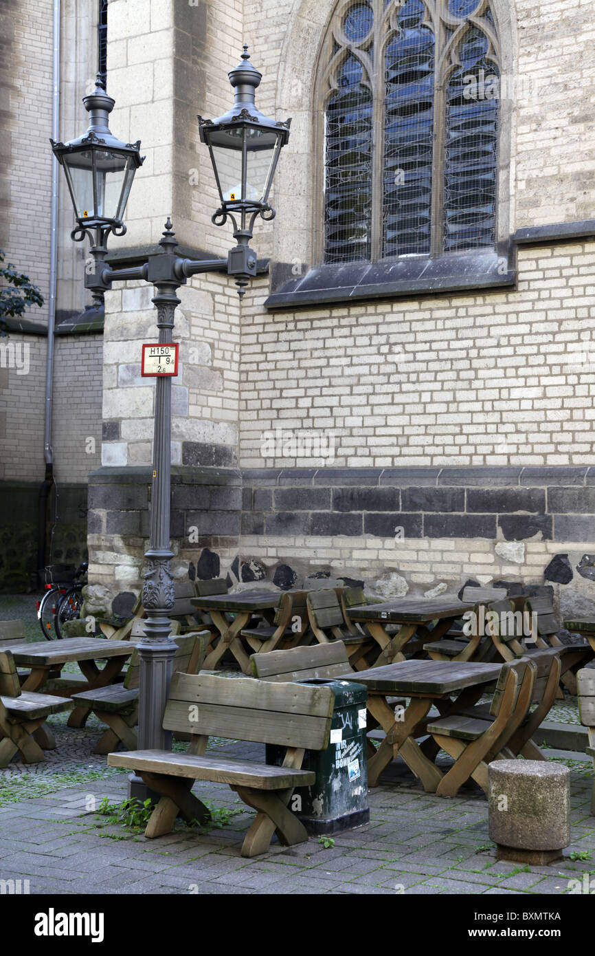 Picnic tables next to church in Bonn and lamp post Stock Photo - Alamy