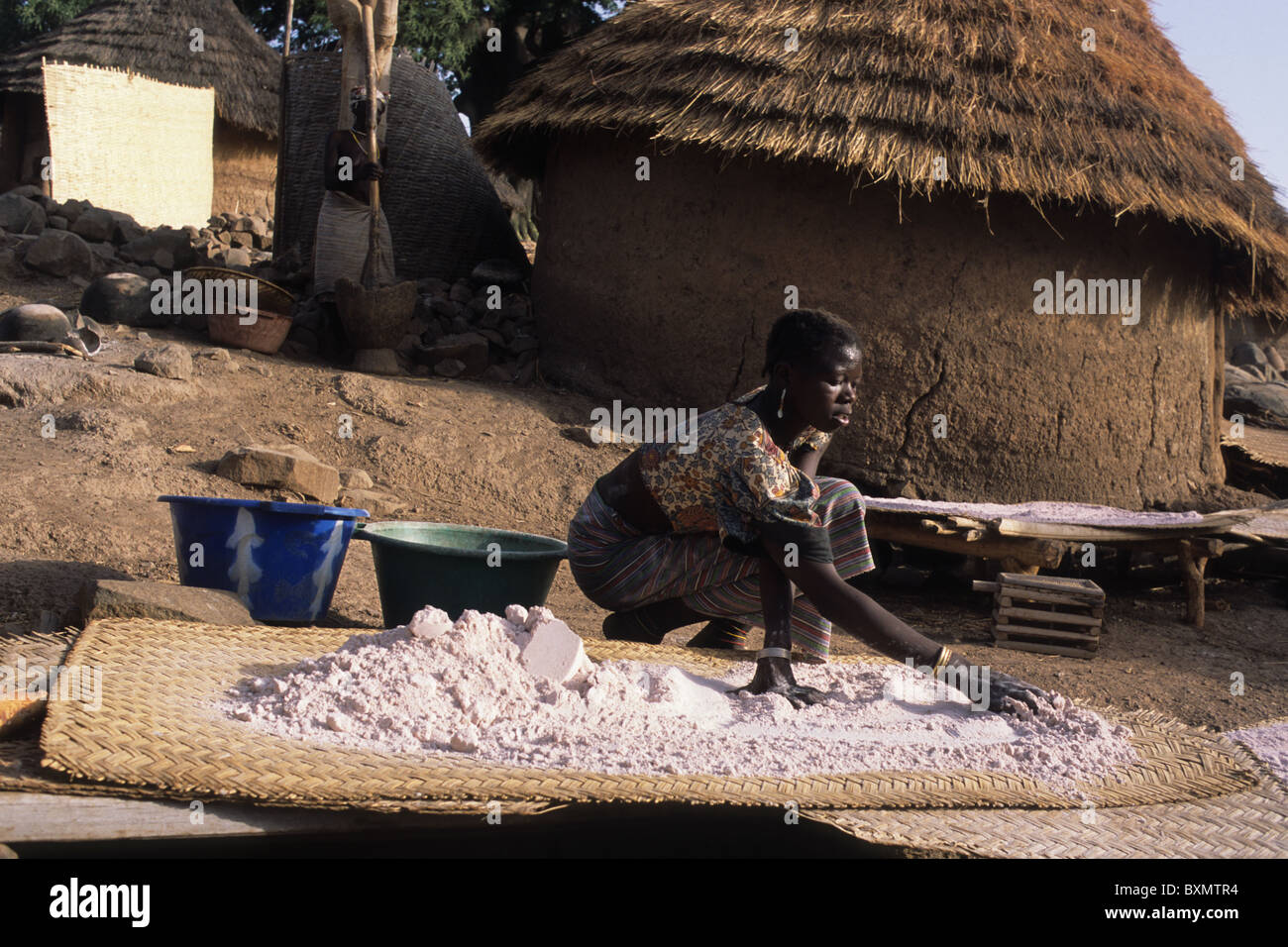 Bedik girl putting on dry ground millet. " Village of Iwol " Bassari ...