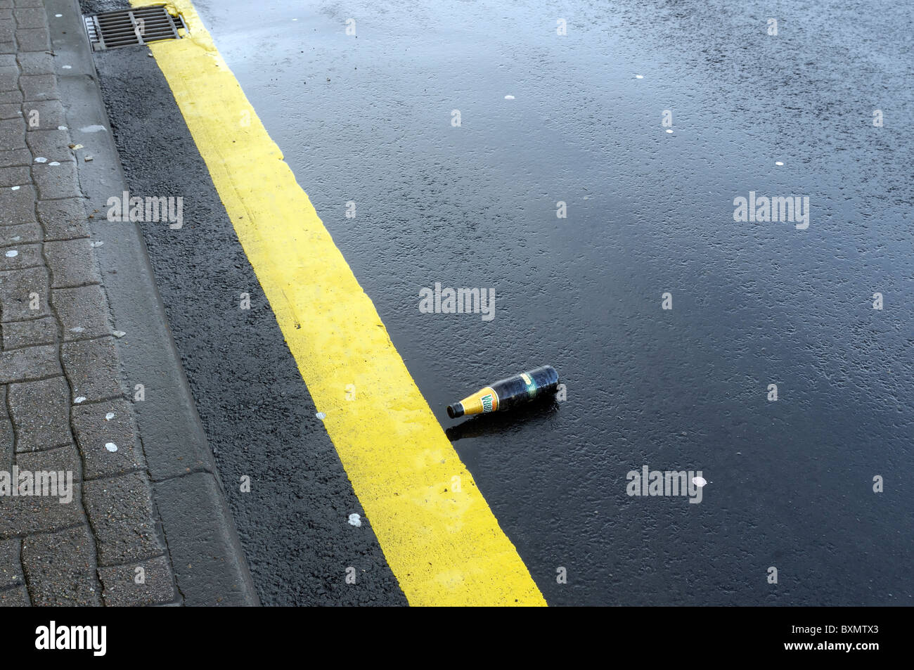 Beer bottle in a gutter in Stornoway Stock Photo - Alamy