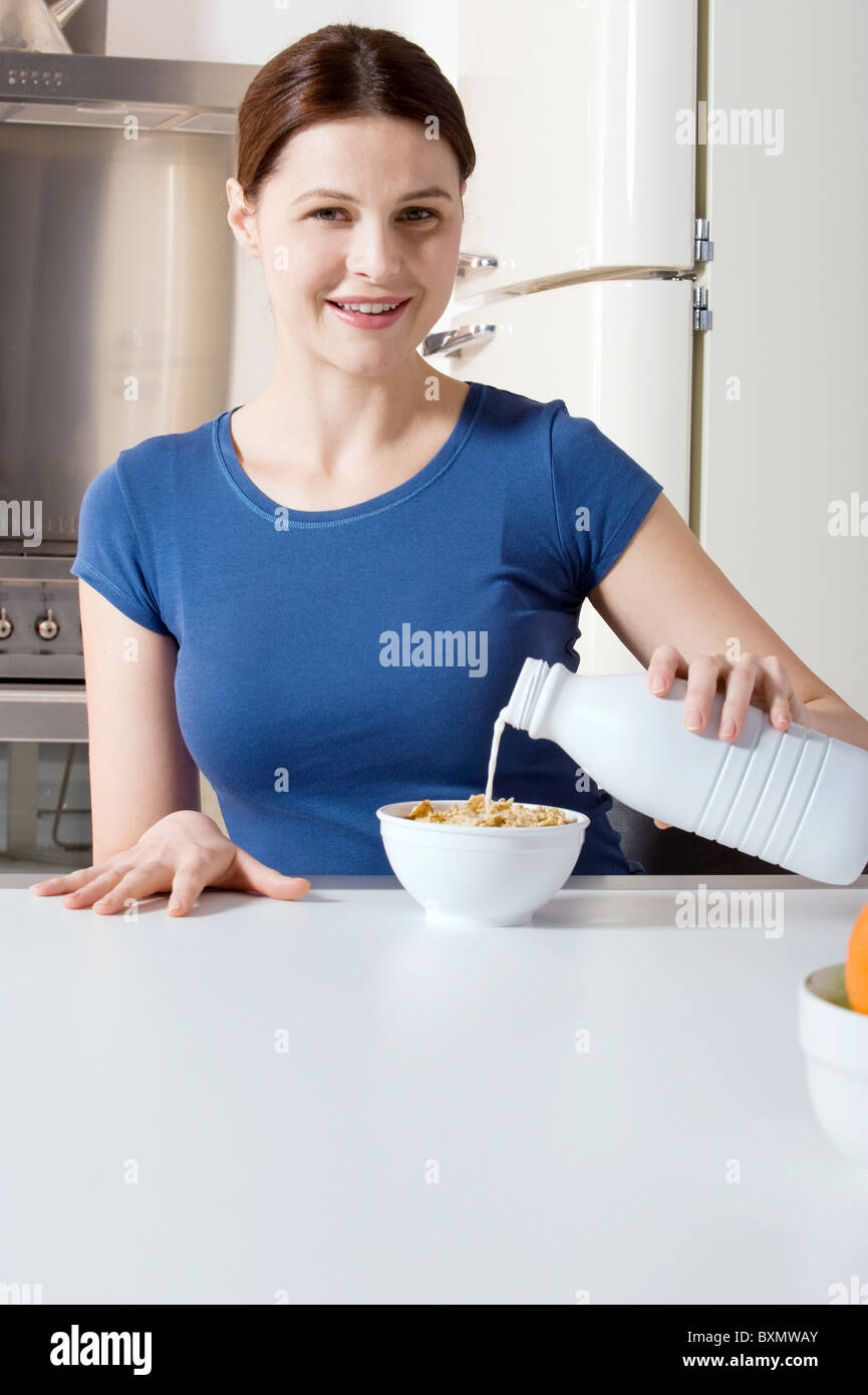 woman eating cereal with milk Stock Photo - Alamy