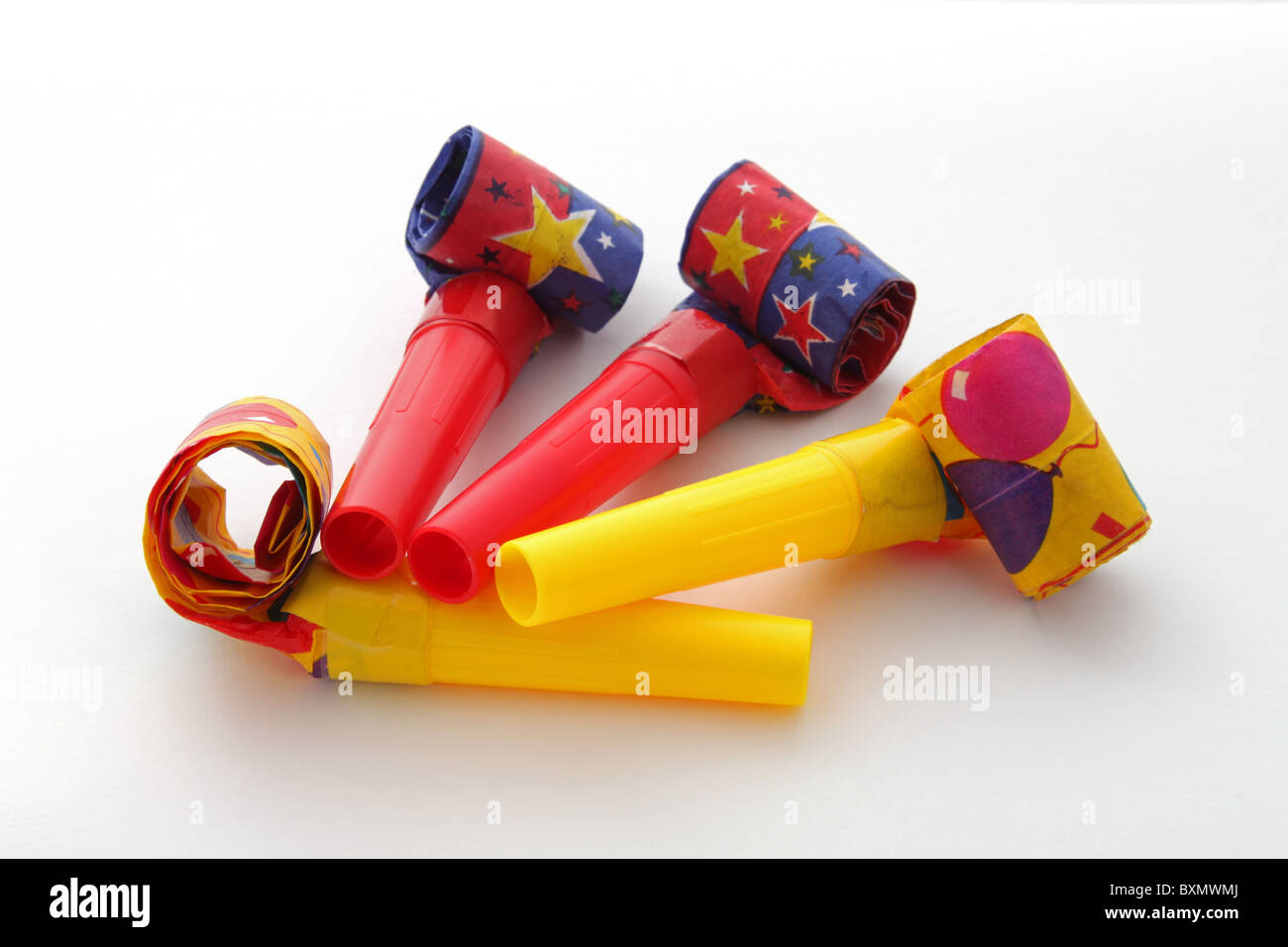Party blowers on a plain white background Stock Photo - Alamy