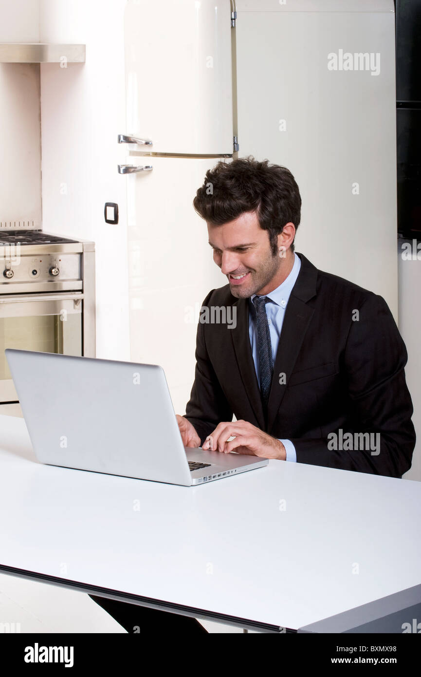 man in the kitchen with laptop Stock Photo - Alamy