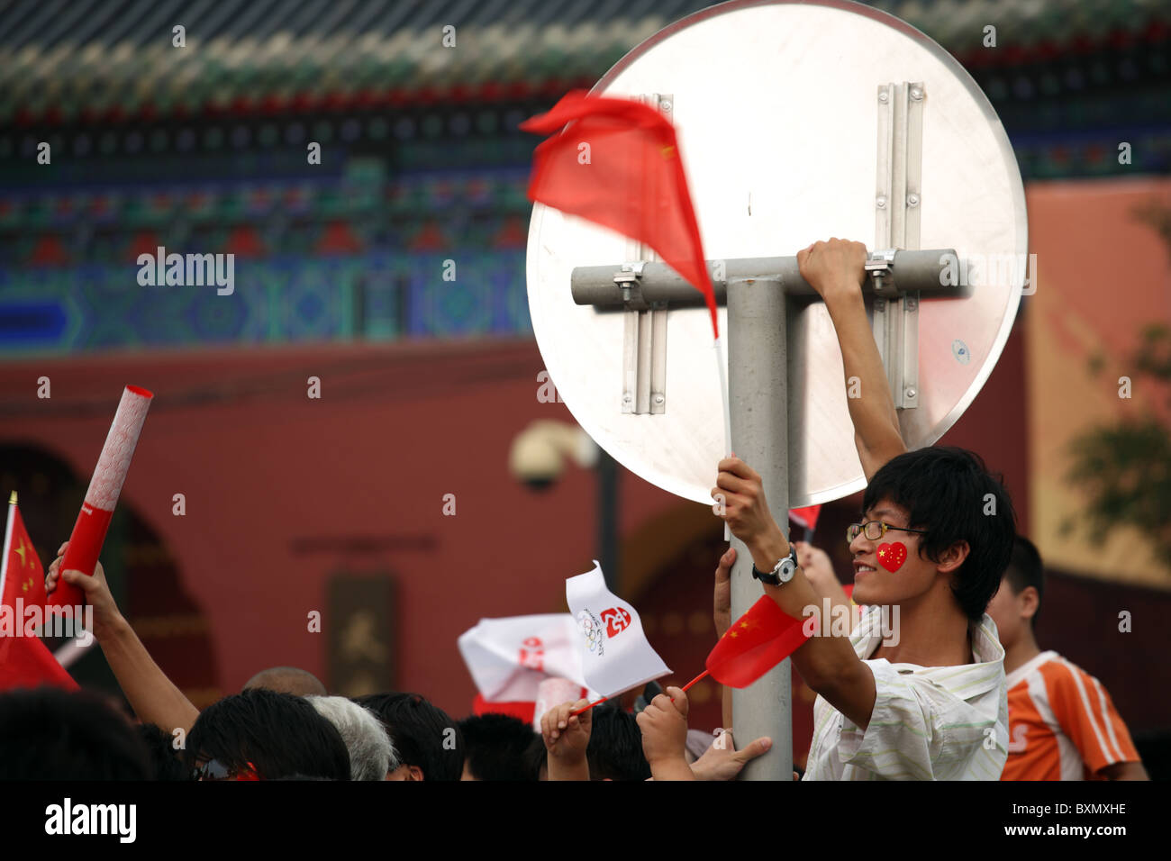 Man climbs pole to obtain better view of Pre-Olympic Games Parade ...