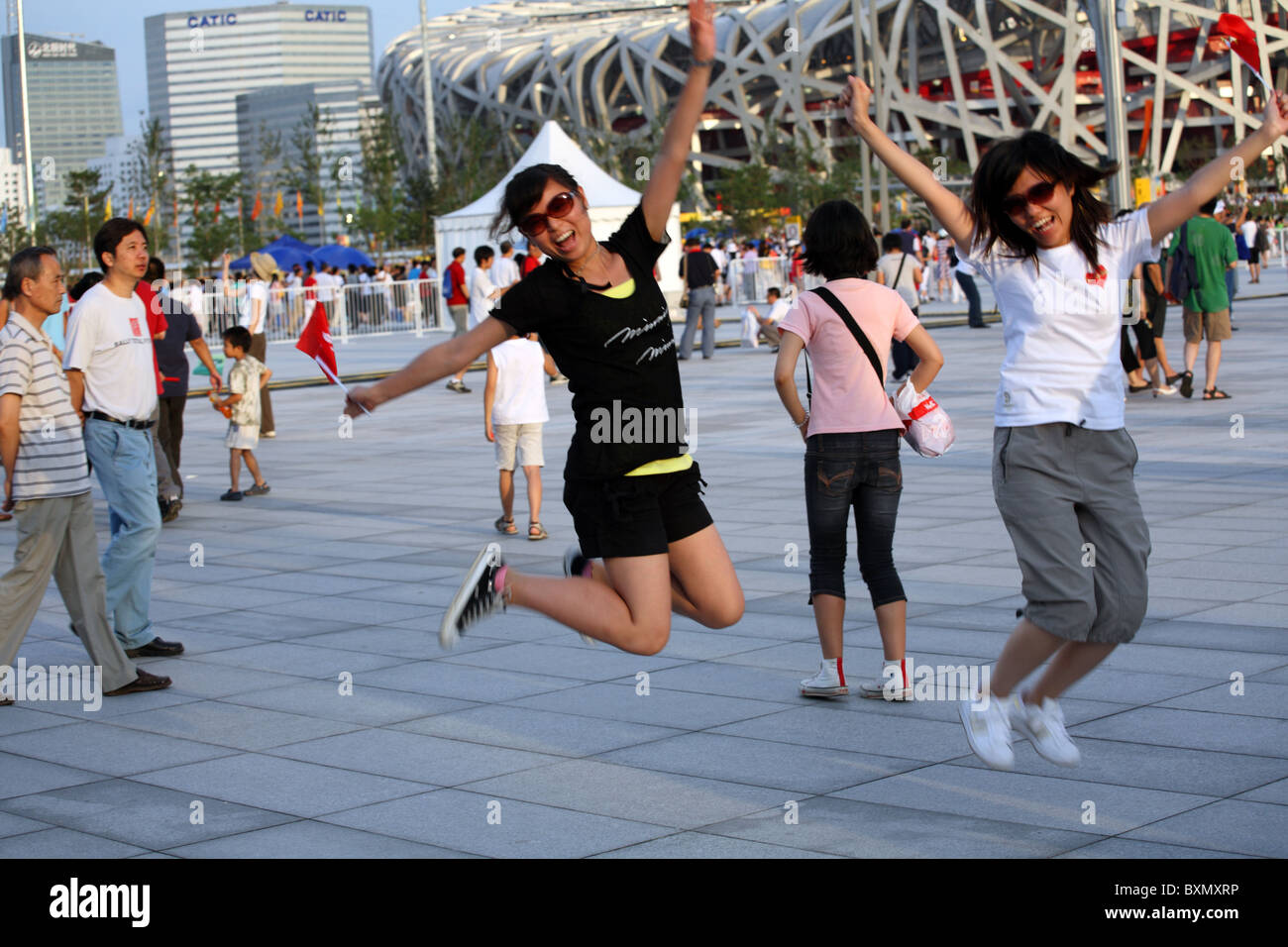 Women leaping outside the Bird's Nest Stadium, Olympic Park, Beijing ...