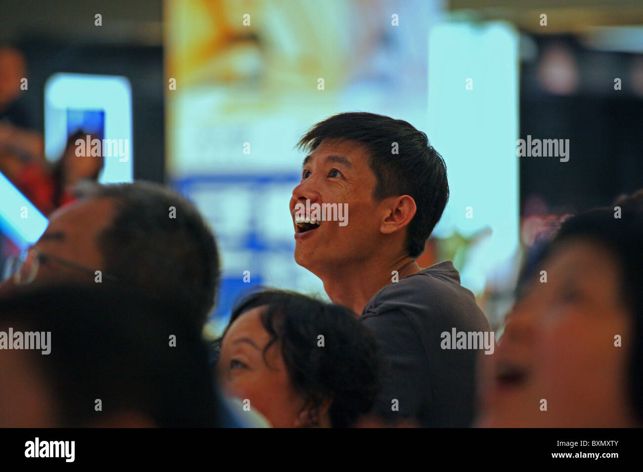 Crowd watching Olympic Games on TV Screen at Shopping Mall, Beijing ...
