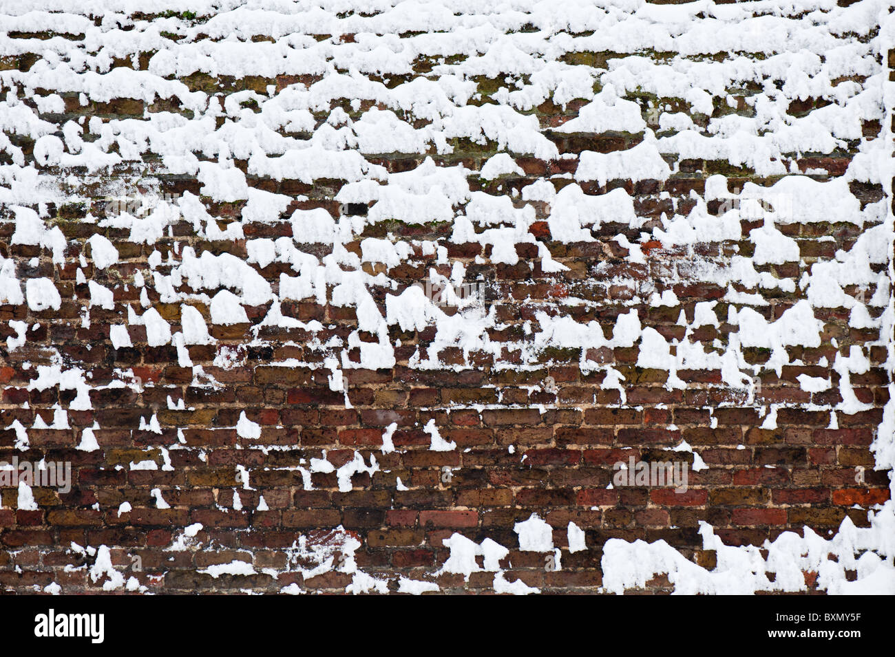 Brick wall covered in snow Stock Photo - Alamy