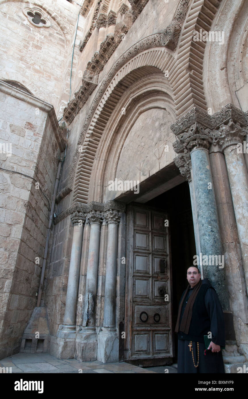 Franciscan friar standing at the entrance gte to the church of Holy ...