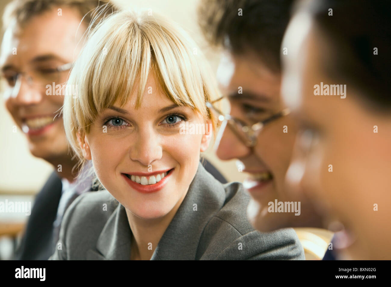 Portrait of confident colleague sitting between her co-workers Stock ...
