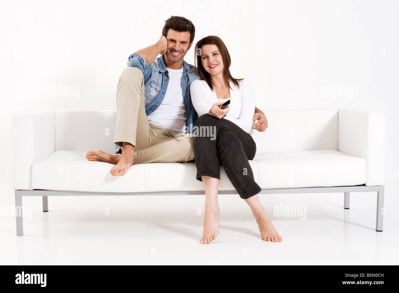 Couple on sofa watching Cut Out Stock Images & Pictures - Alamy