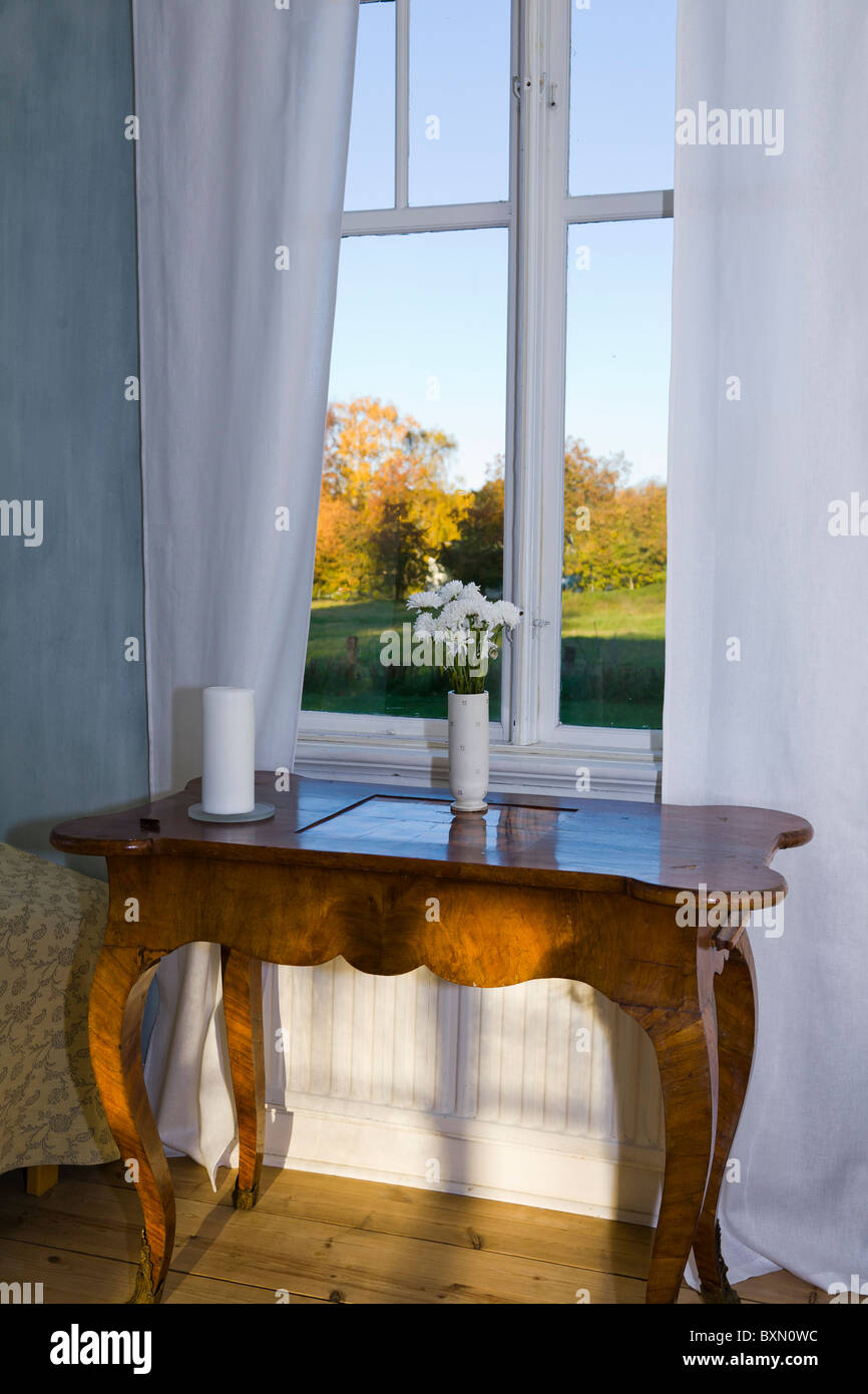 Rococo table standing by window Stock Photo - Alamy