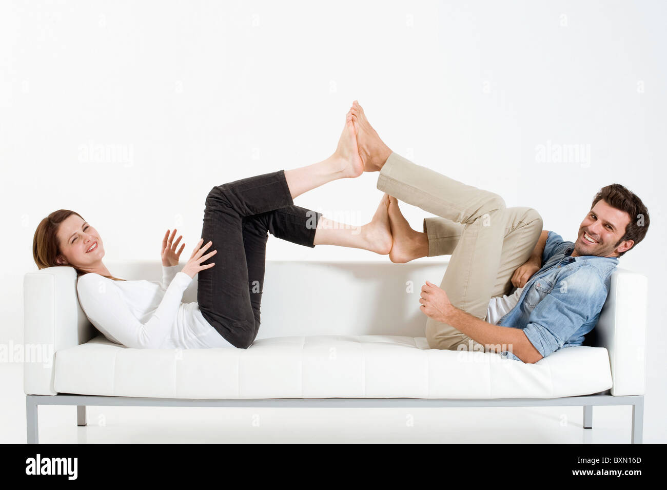 couple on the couch feet against feet Stock Photo - Alamy