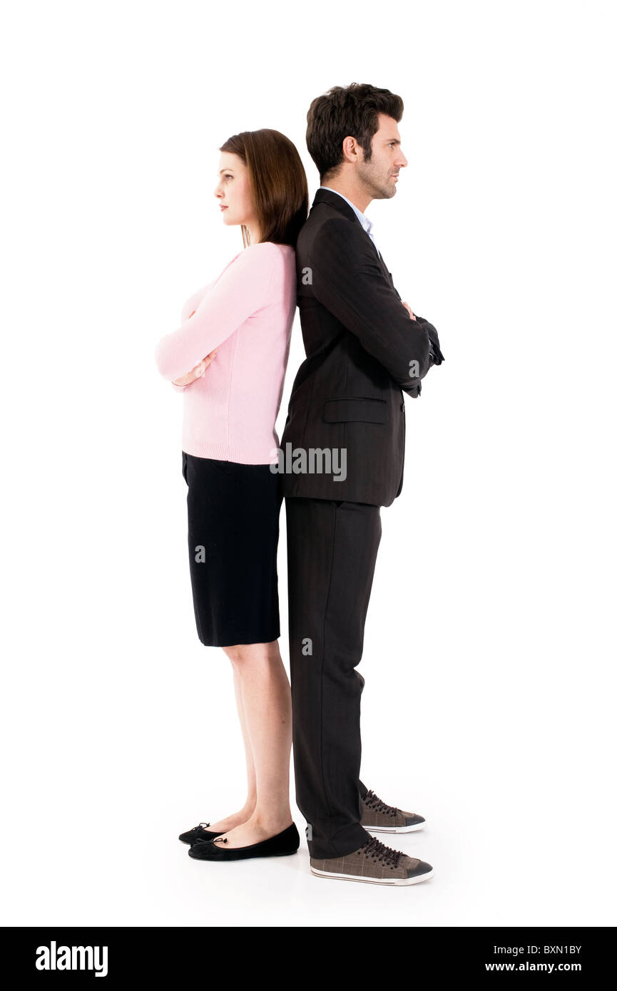 Couple standing back to back Stock Photo - Alamy