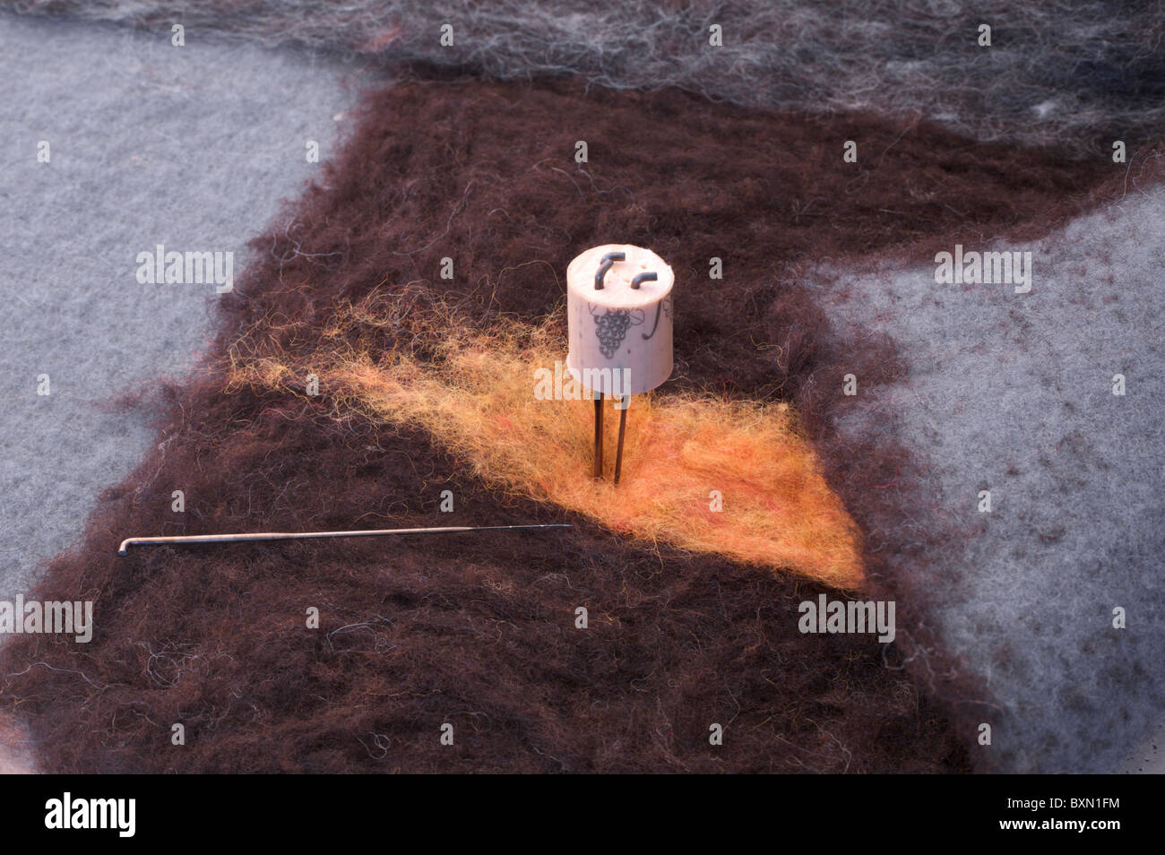 A fabric is being made by needle felting, also referred to as dry ...