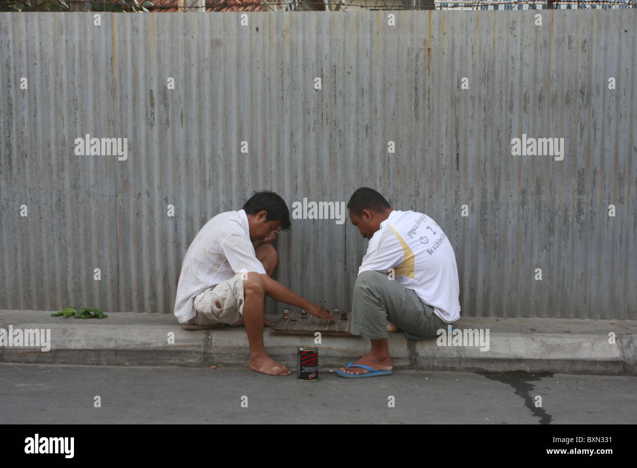 Two men play a board game on the street in Phnom Penh, Cambodia Stock ...