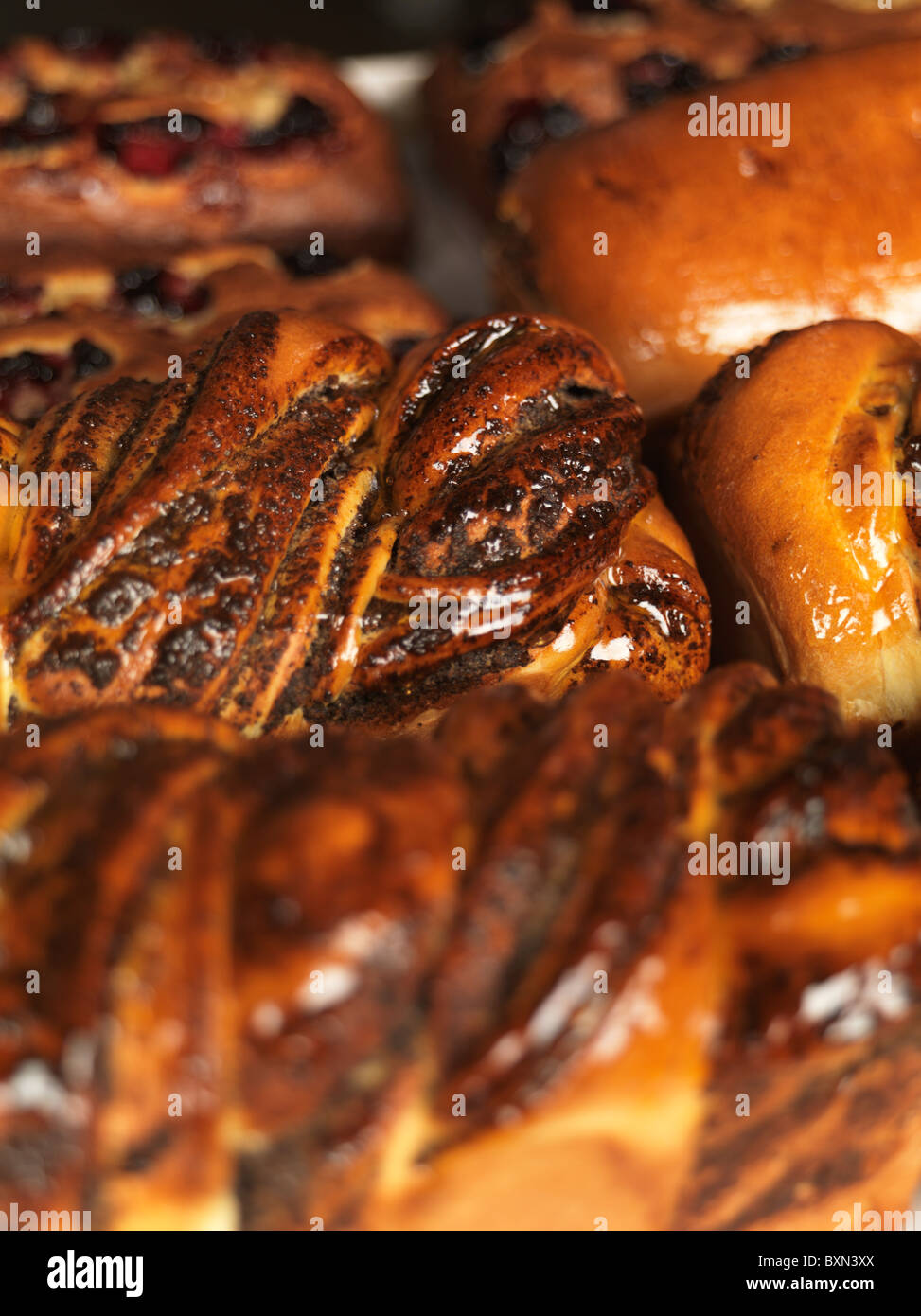 Freshly baked sweet glazed bread on a baking tray Stock Photo - Alamy