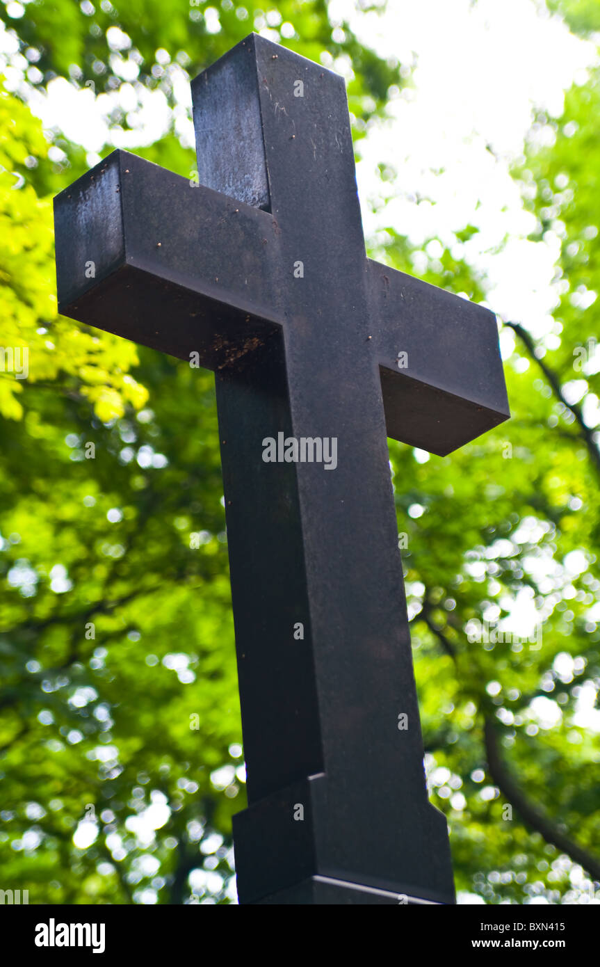 black wooden cross on green plants background Stock Photo - Alamy