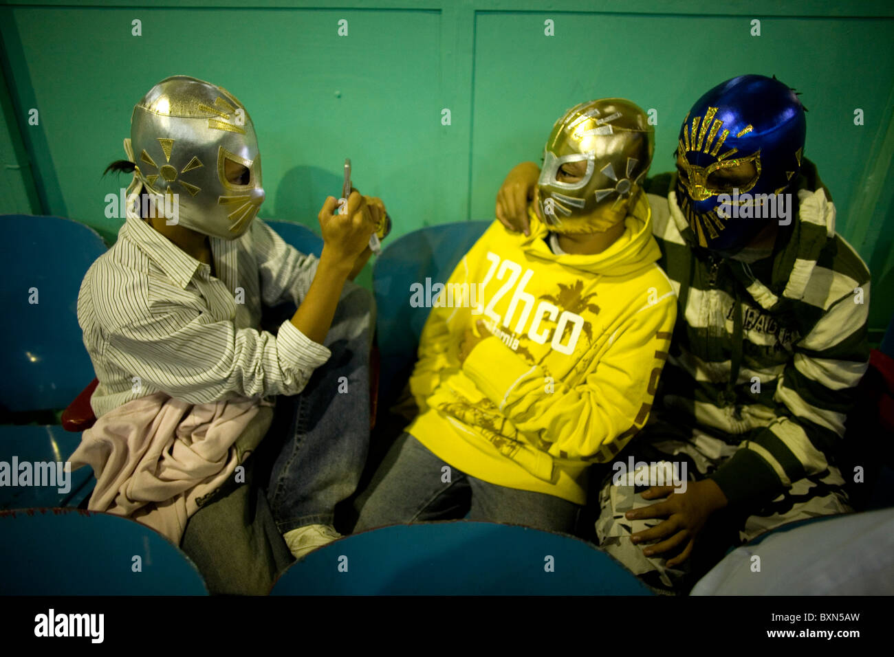 Lucha Libre wrestling fans take pictures as they wait for the start of ...