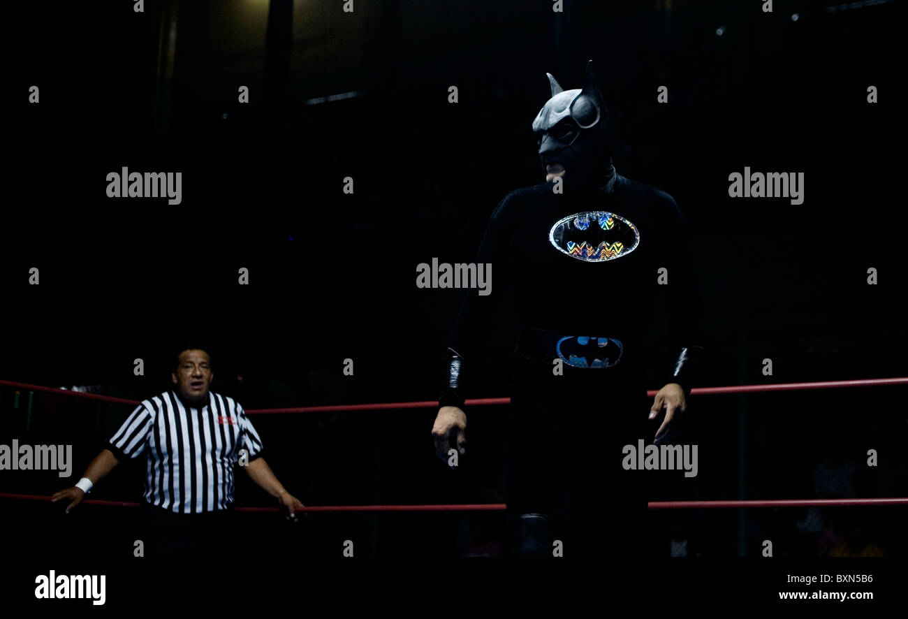 A wrestler disguised as super hero Batman celebrates during a Lucha ...