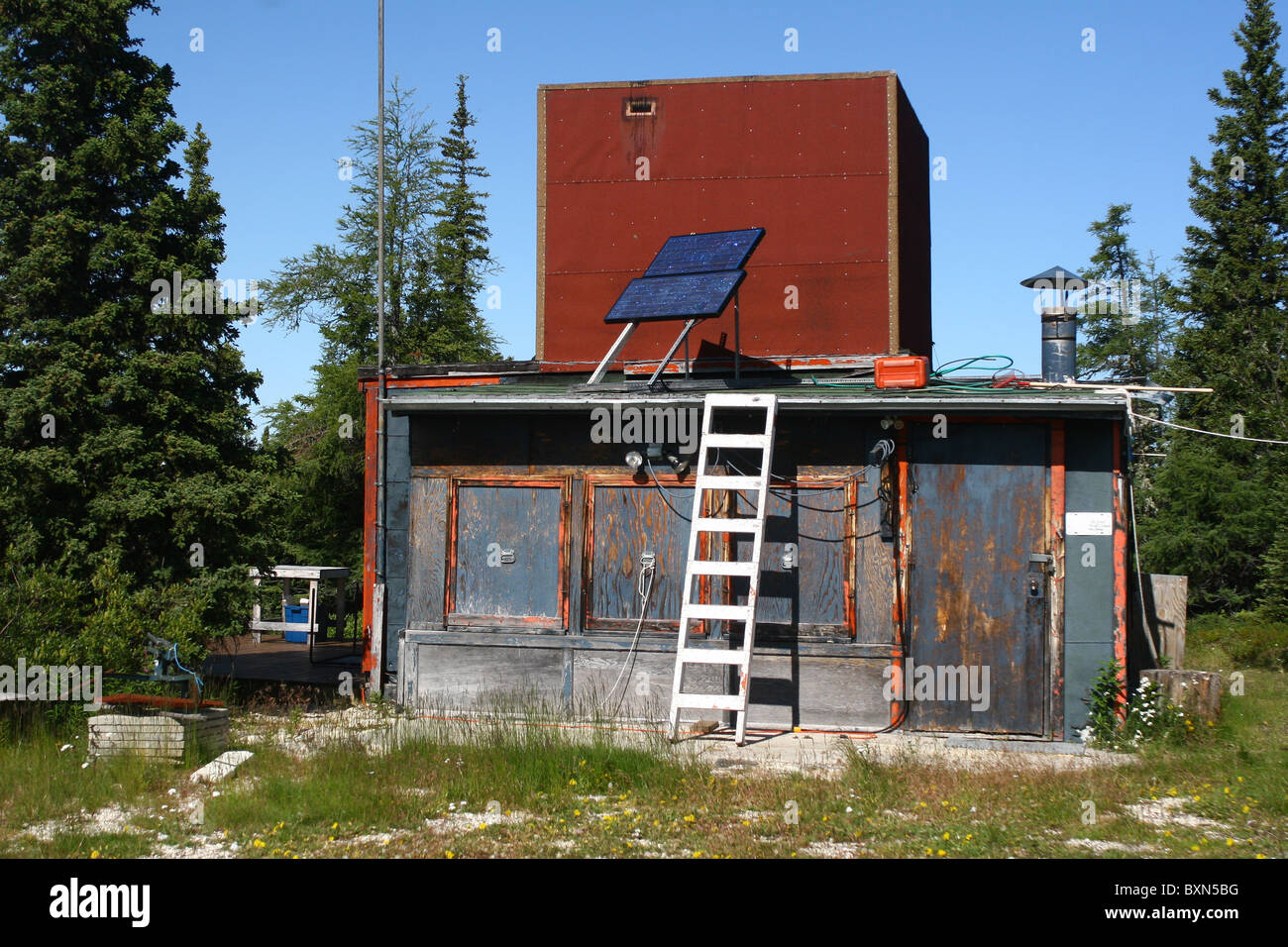 Shack in the woods with solar panel Stock Photo - Alamy