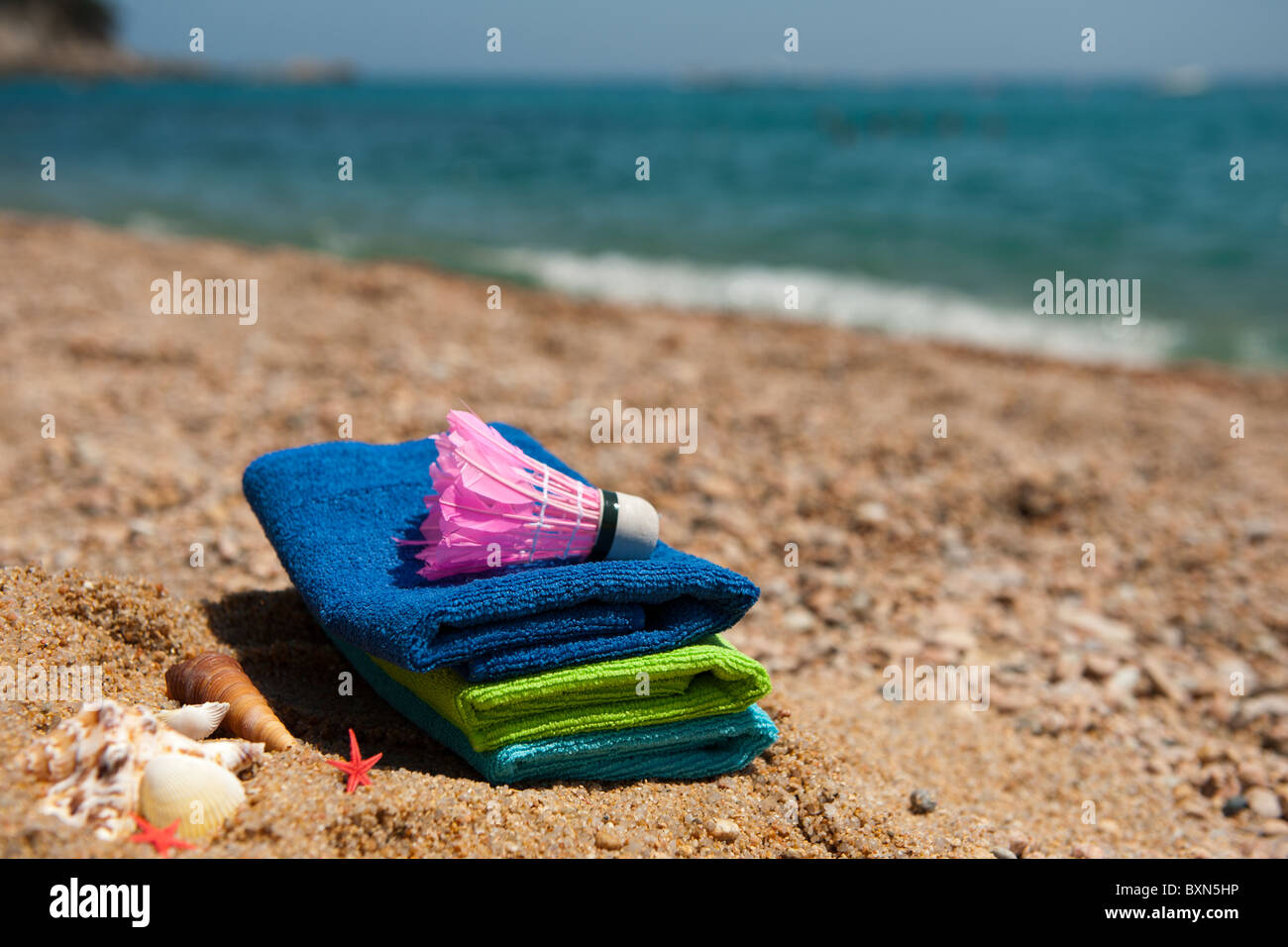 towels and badminton shuttle with shells at the beach Stock Photo - Alamy