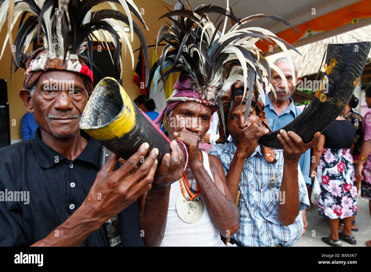 Old man wearing traditional headdress made from cockerel feathers ...