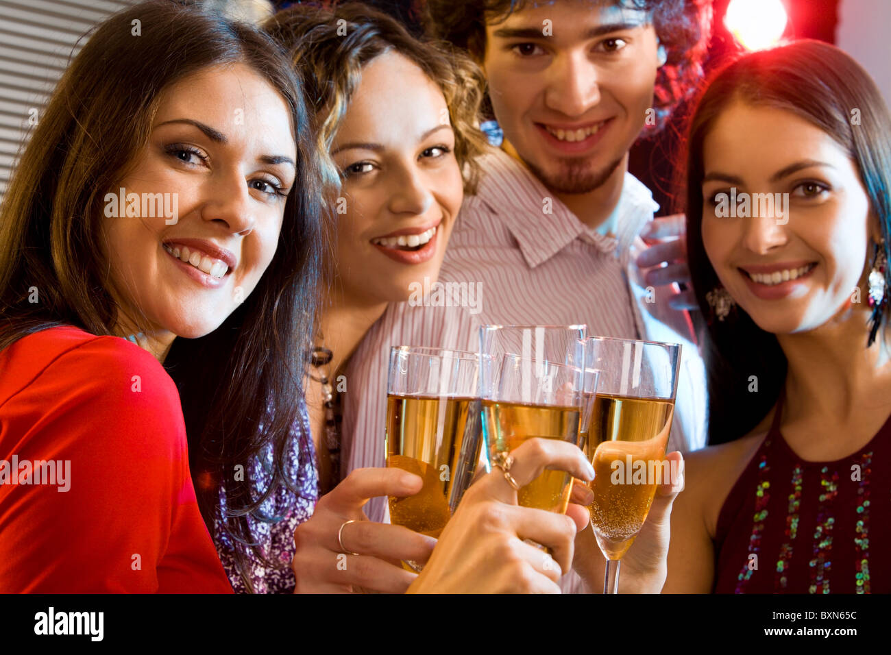 Portrait of students holding the glasses making a toast Stock Photo - Alamy