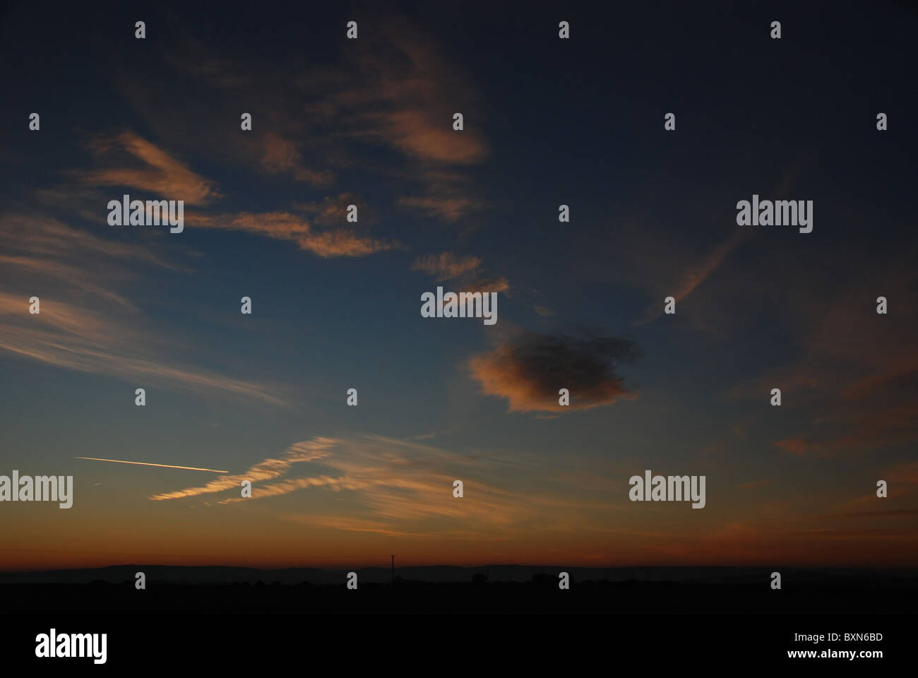 the blue and red sky as the sun comes up in the morning Stock Photo - Alamy