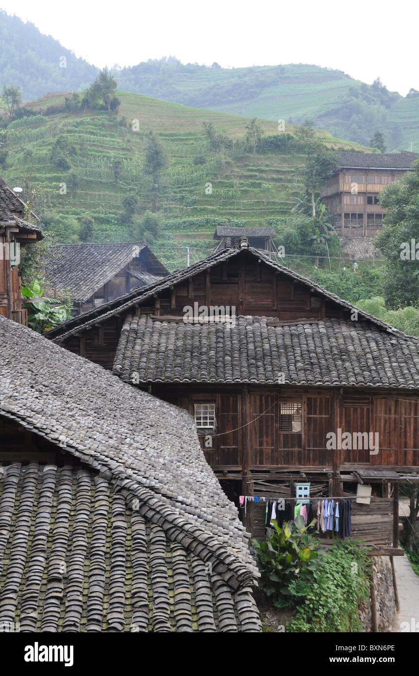 Wooden buildings in a stunning scenery at Longji Rice Terrace, Southern ...