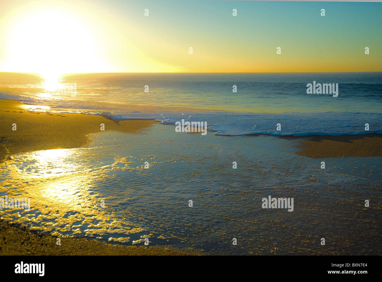 Sun rising with blue water hi-res stock photography and images - Alamy