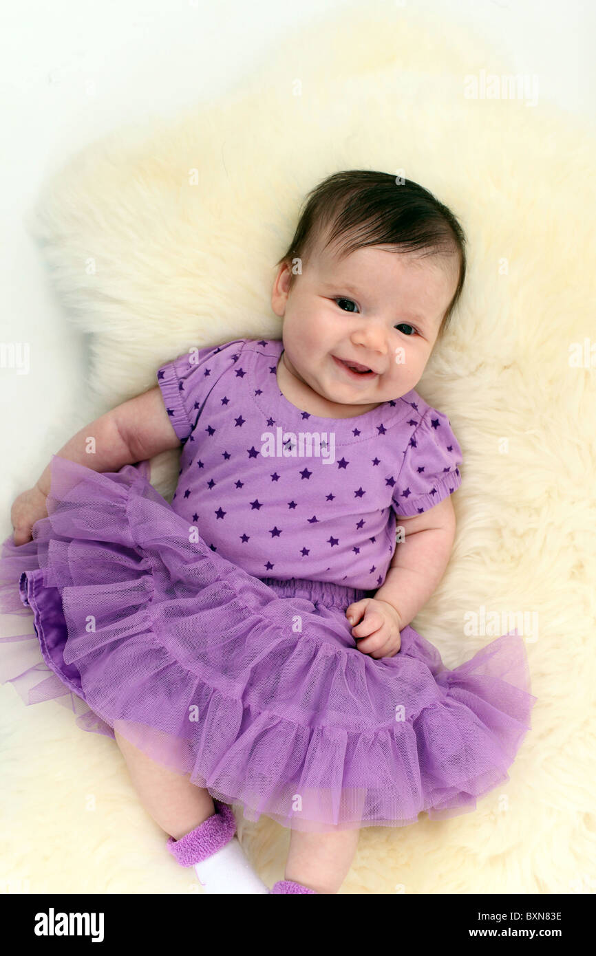 Infant baby girl in studio laying on back Stock Photo - Alamy