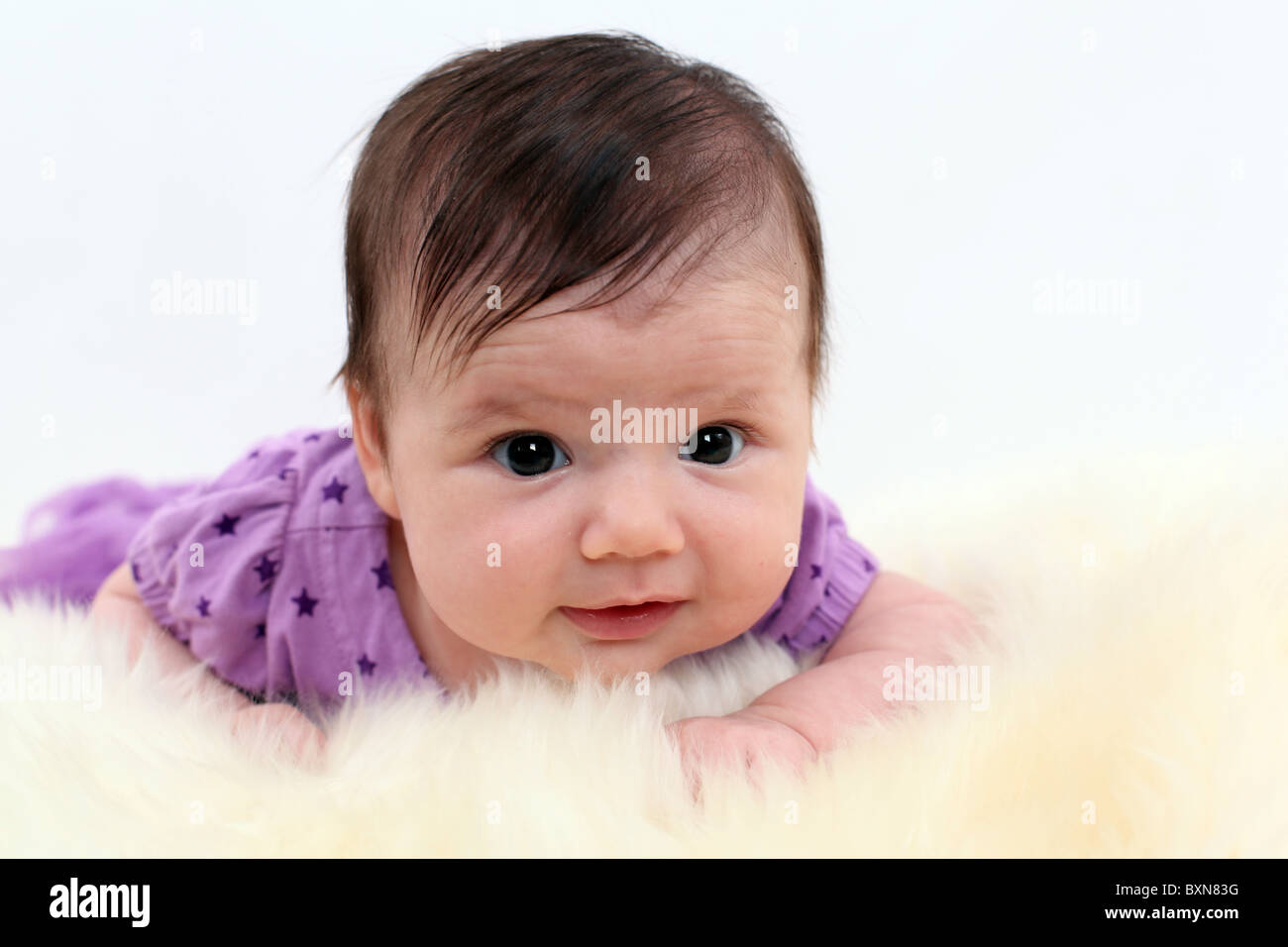 Infant baby girl in studio laying on stomach, enjoying tummy time Stock ...