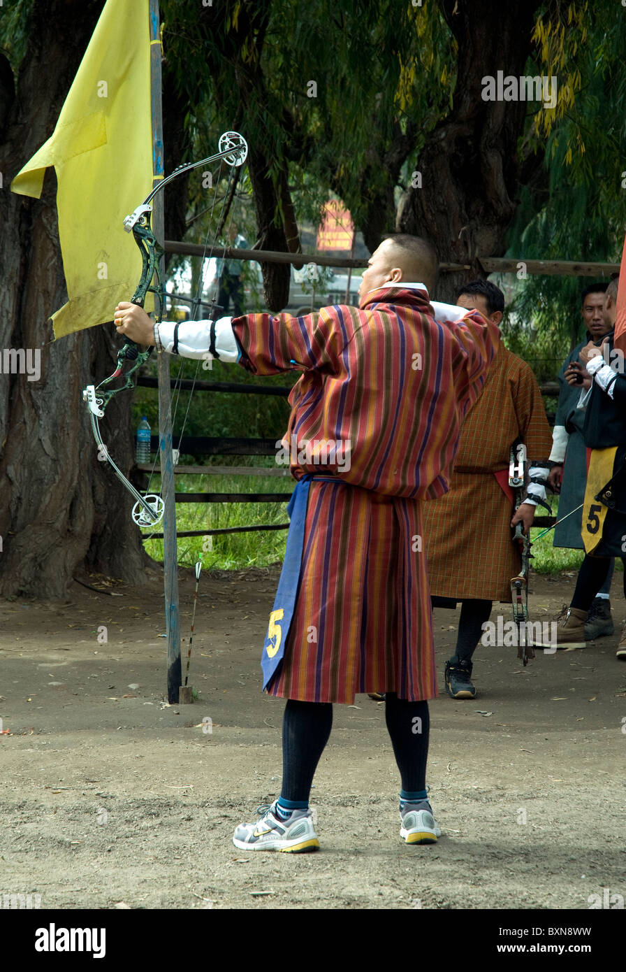 An archer wearing national dress (except for shoes) takes aim in a ...