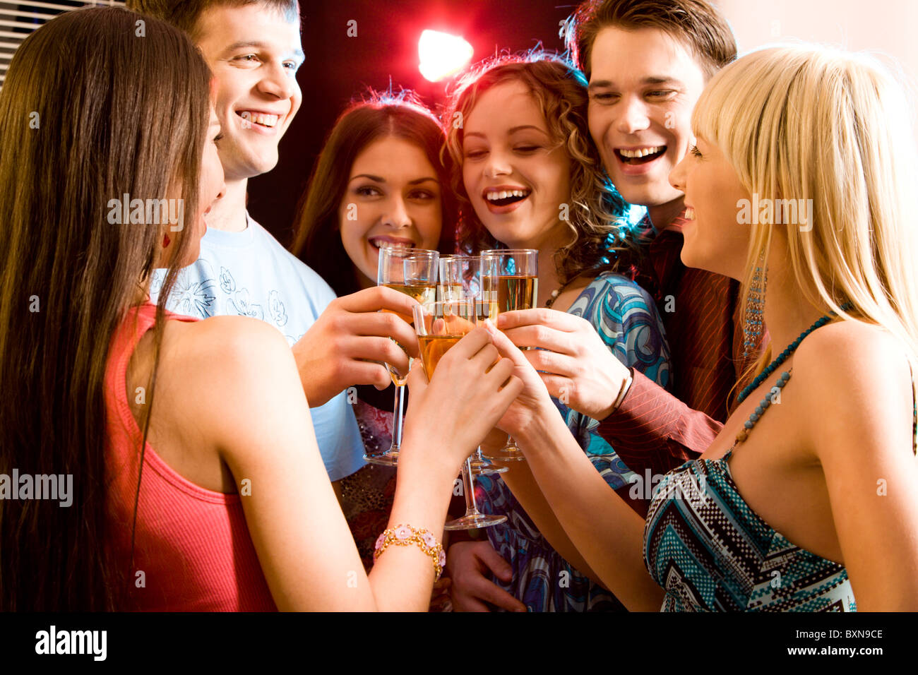 Friends enjoying a celebratory drinks of champagne Stock Photo - Alamy