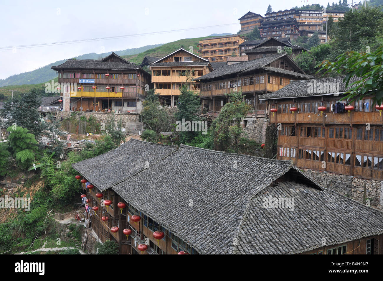 Wooden buildings in a stunning scenery at Longji Rice Terrace, Southern ...