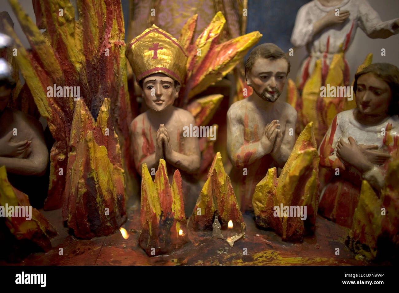 Sculptures of priests and a bishop burning in hell are displayed in a ...