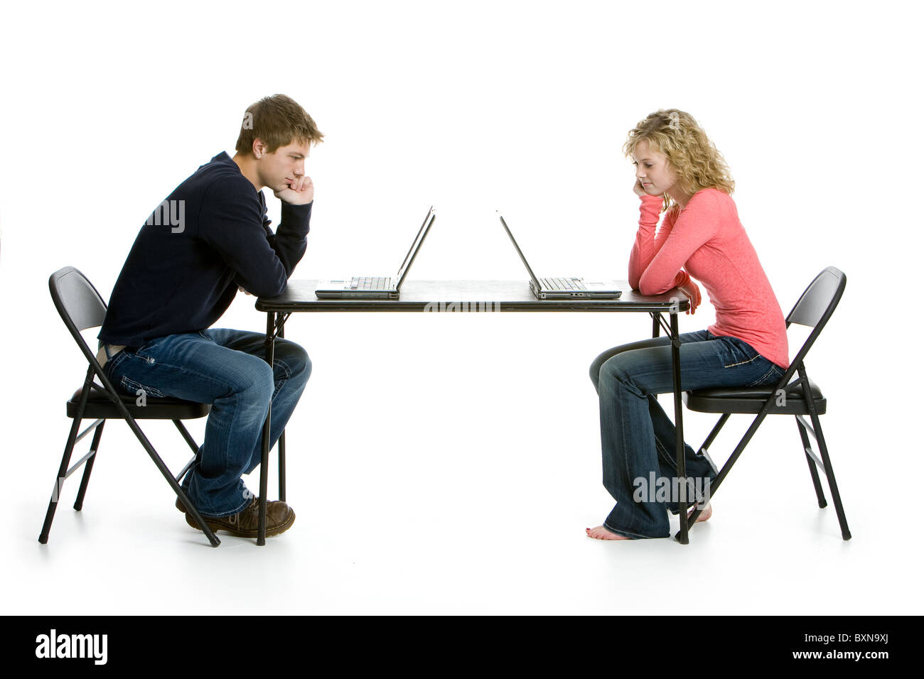 Teenage students using laptops on white background in studio Stock ...