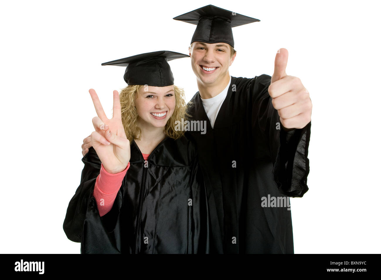Two young happy graduate students in cap and gown Stock Photo - Alamy