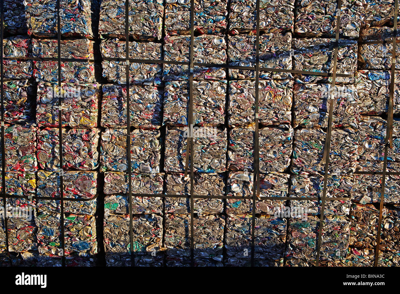 Crushed and compacted aluminum cans are baled and stacked, ready for ...