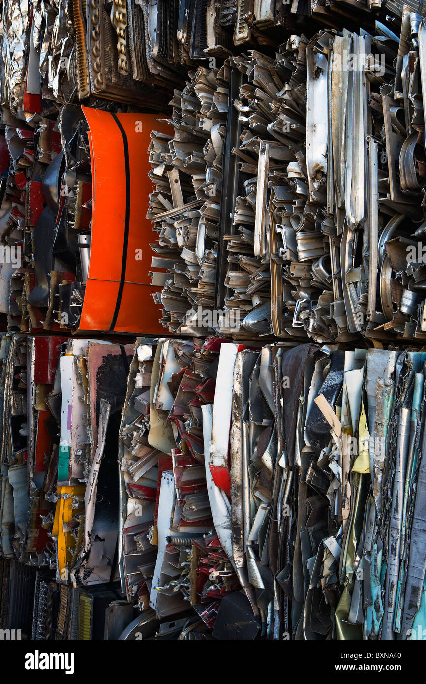 Colorful scrap metal is compressed and stacked ready for recycling ...