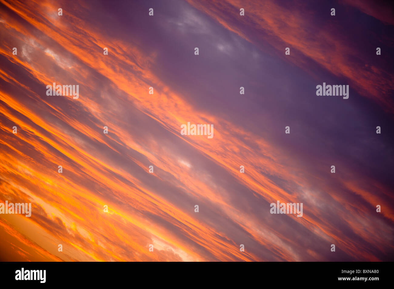 Golden striped sunset clouds diagonal background Stock Photo - Alamy
