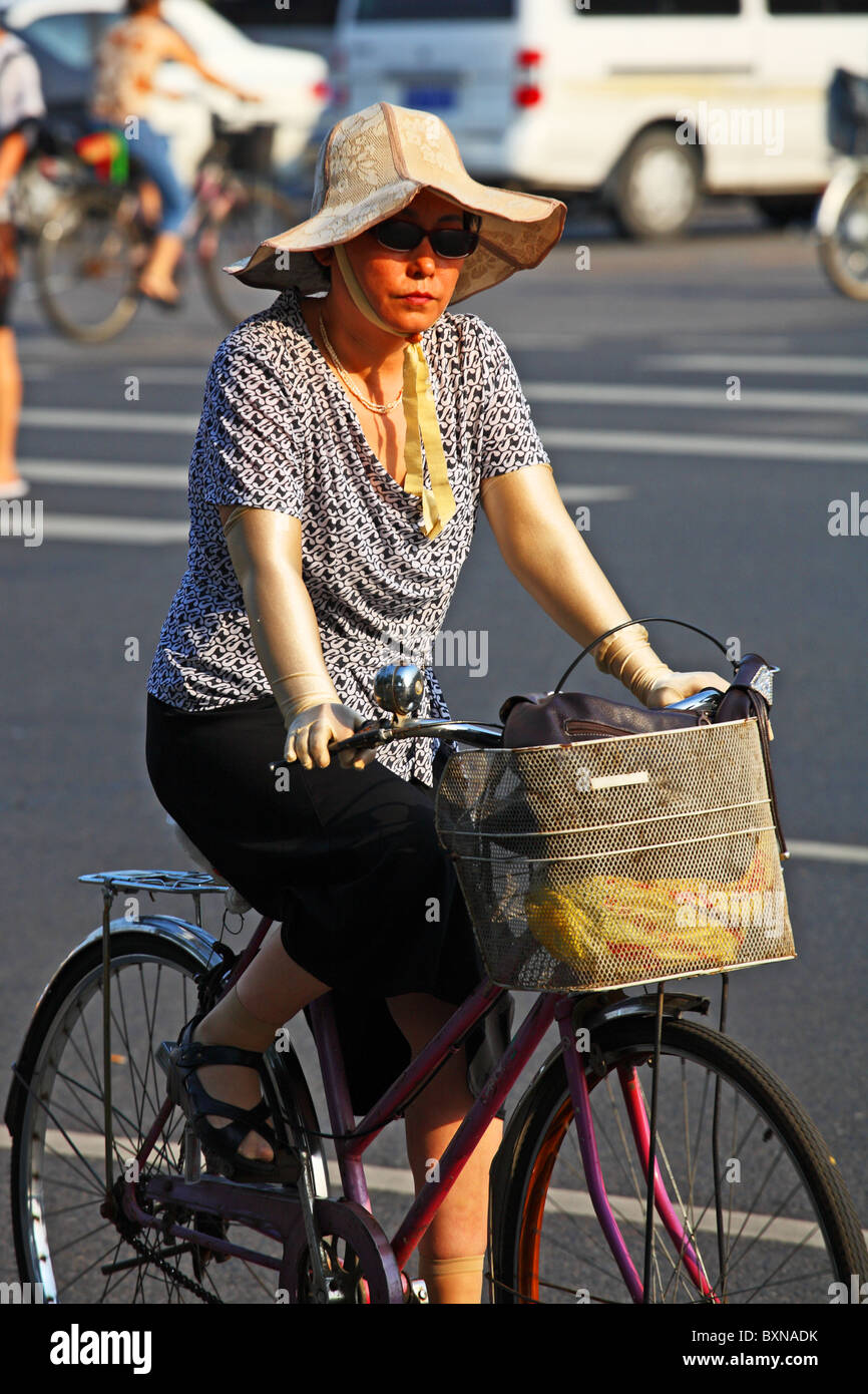 Chinese lady riding bicycle. Beijing, China Stock Photo - Alamy
