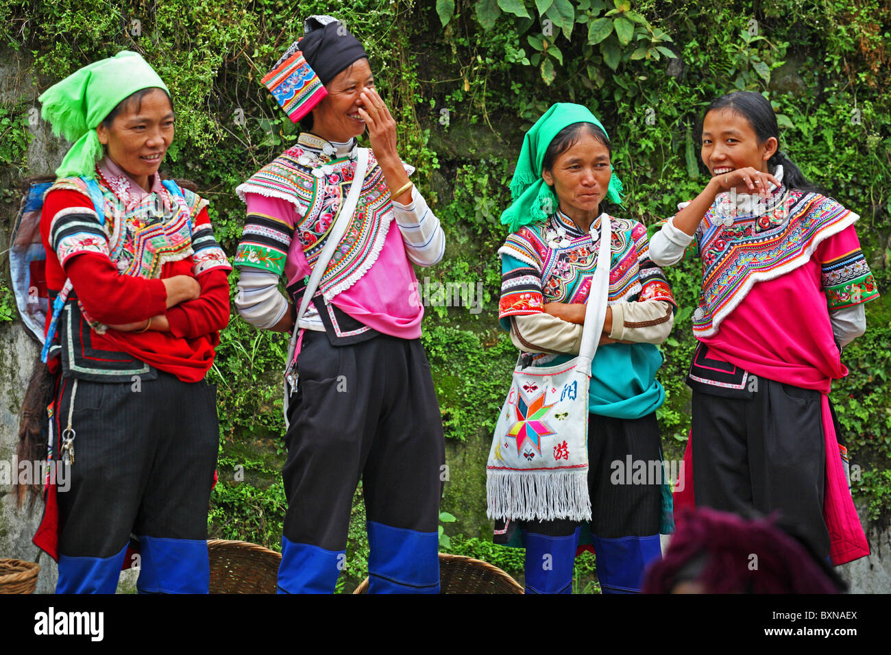 Laughing Yi ethnic minority tribal women at market, Yuanyang, Yunnan ...