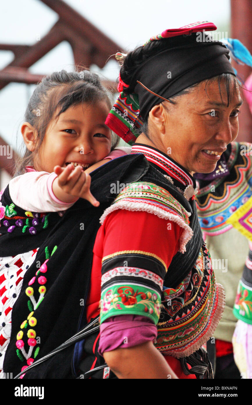 Yi ethnic minority Child with six fingers in market at Yuanyang, Yunnan ...