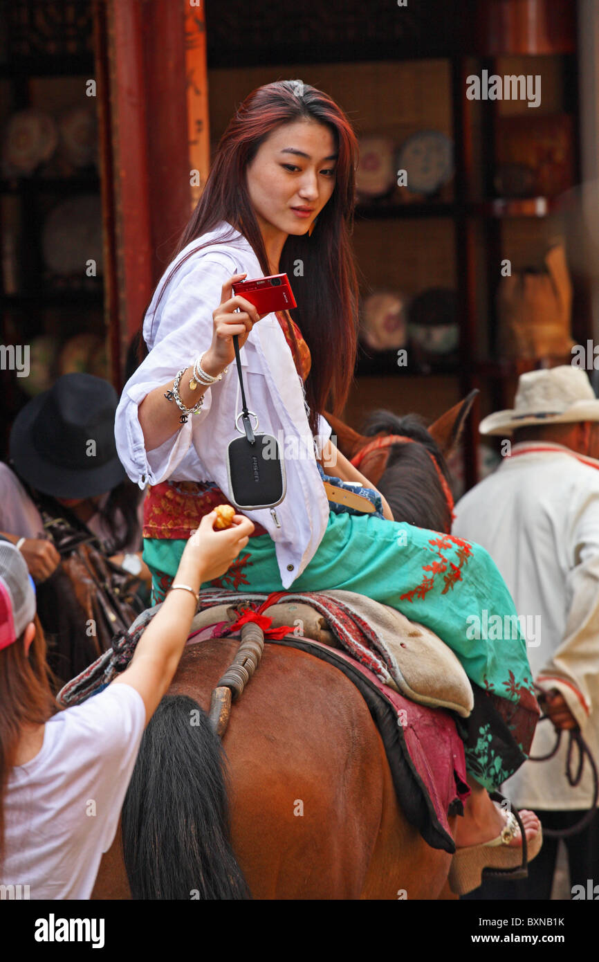 Chinese lady on horse, Lijiang, Yunnan Province, China Stock Photo - Alamy