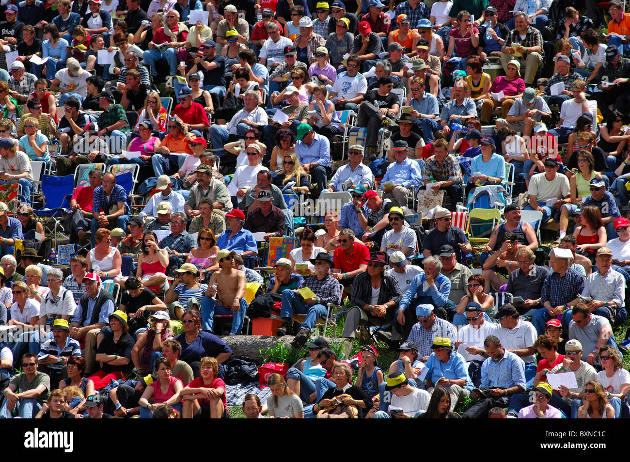 Sitting spectators of a public event on a summer day, crowd picture ...